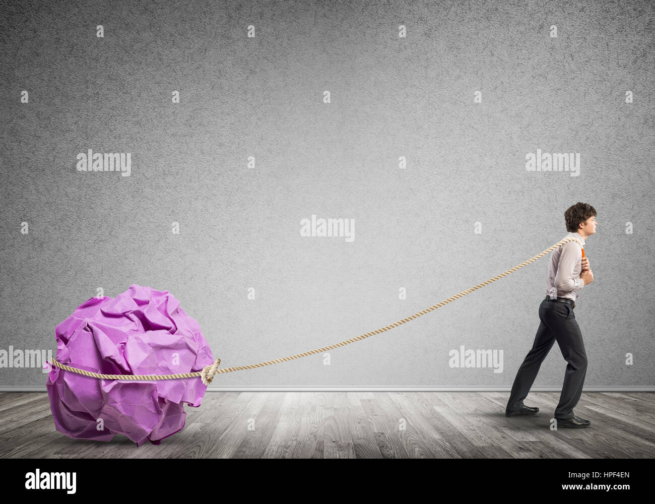Young man in room making huge paper ball move Stock Photo - Alamy