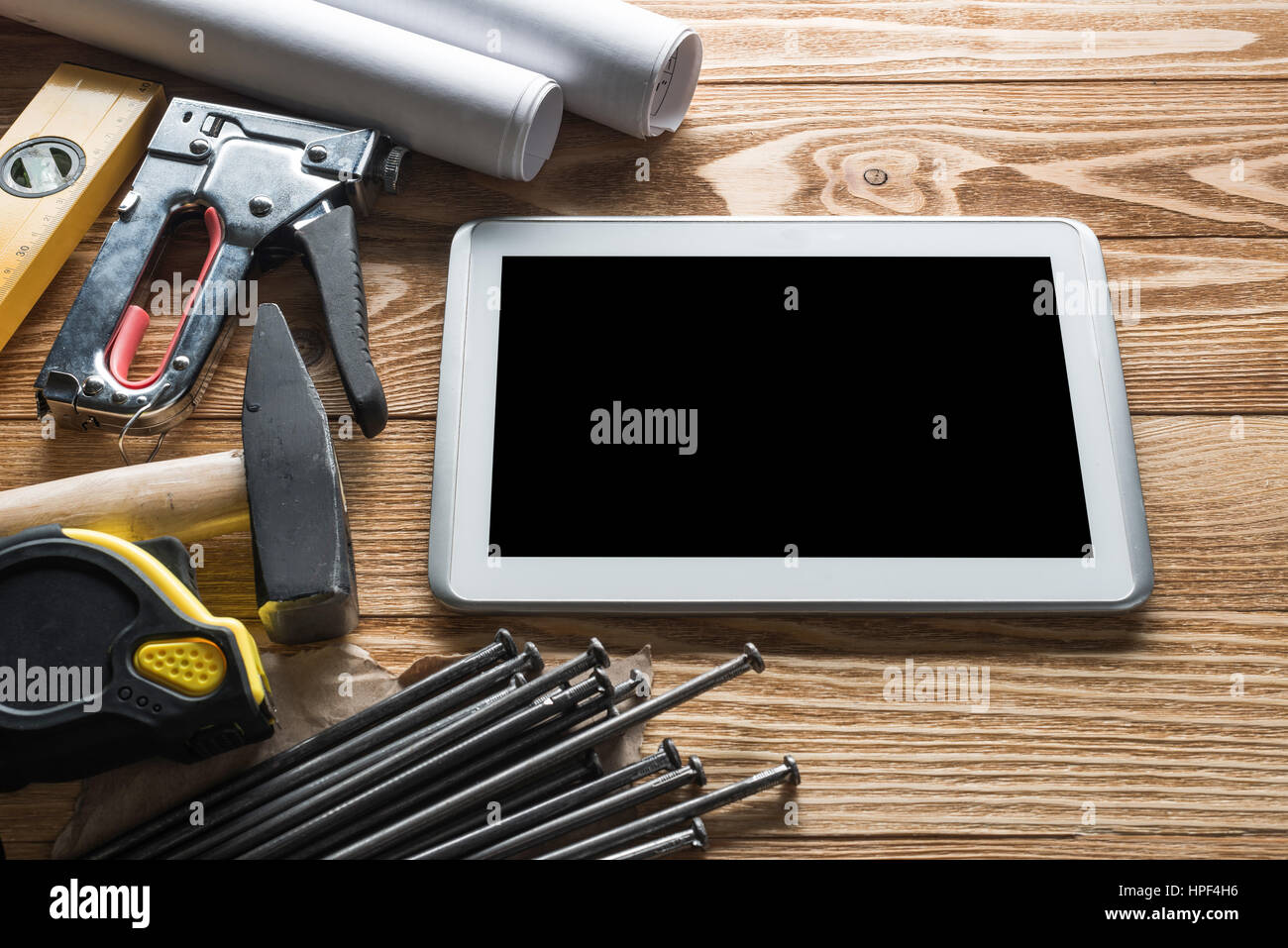 Variety of tools of builder and tablet pc on wooden texture table Stock ...
