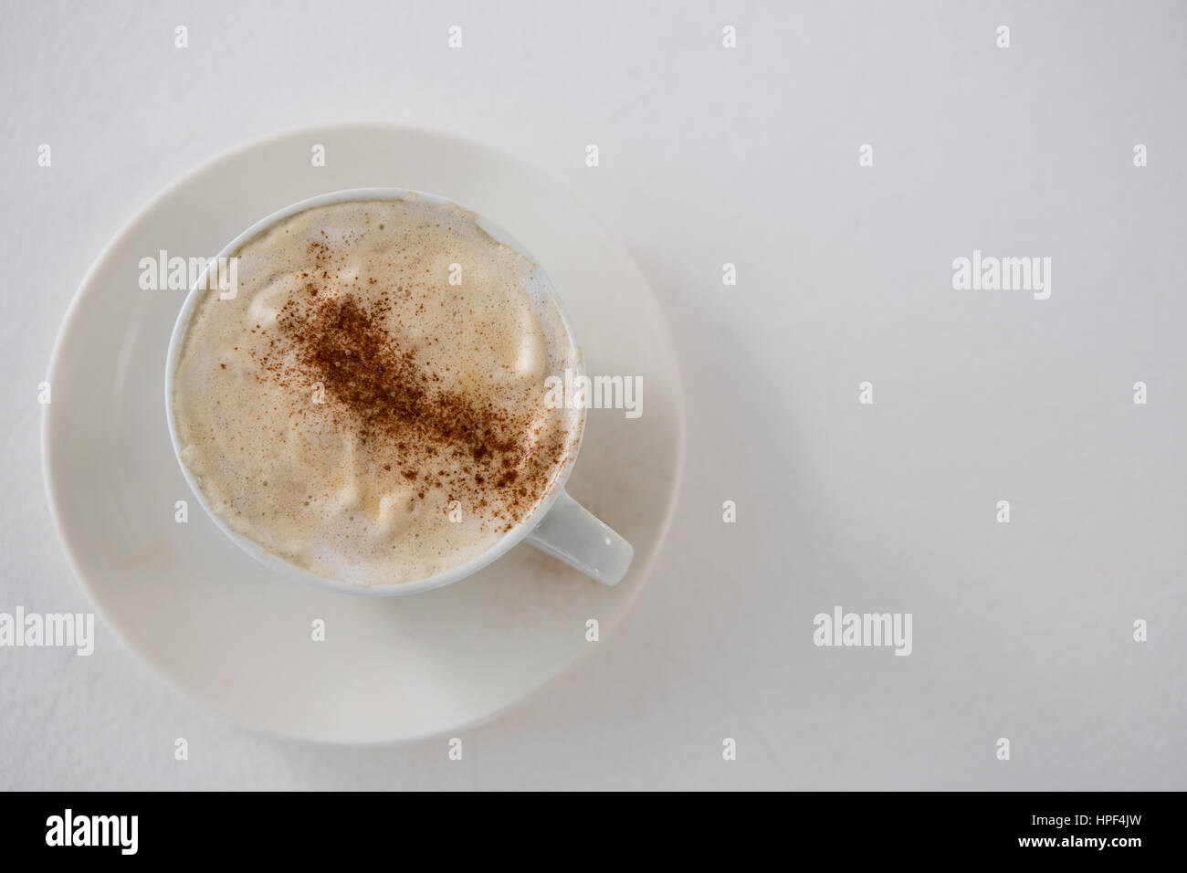 Close-up of coffee cup with creamy froth on white background Stock ...