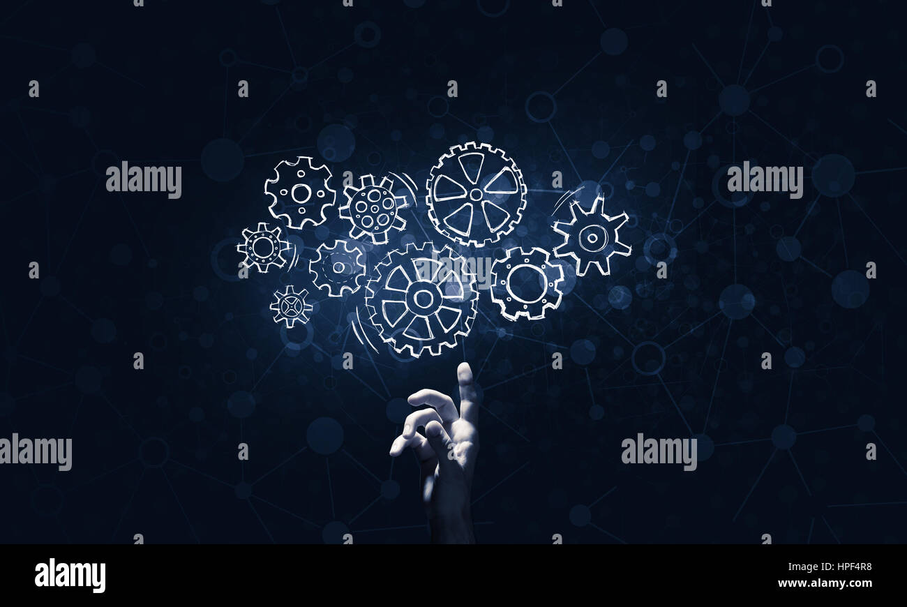 Close of businessman hand pointing with finger at gear mechanism Stock ...