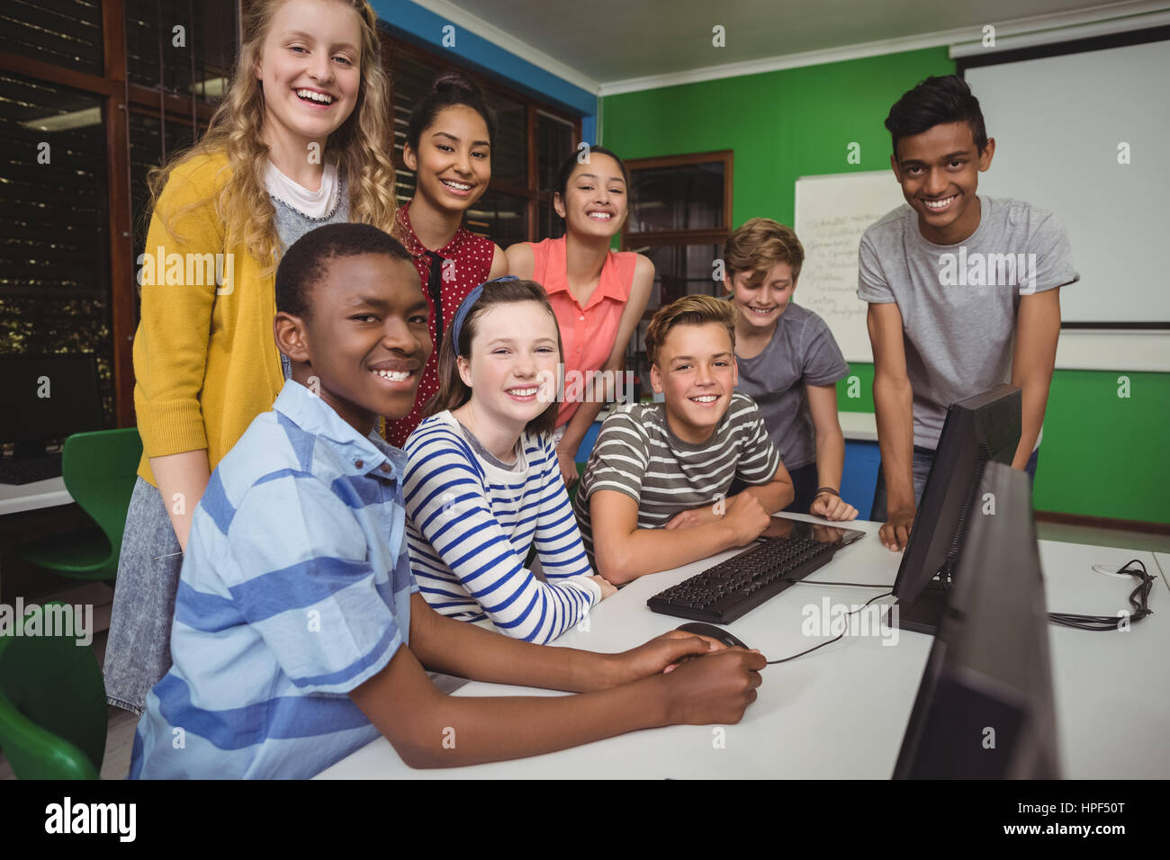Group of students sitting at desk in classroom Stock Photo - Alamy