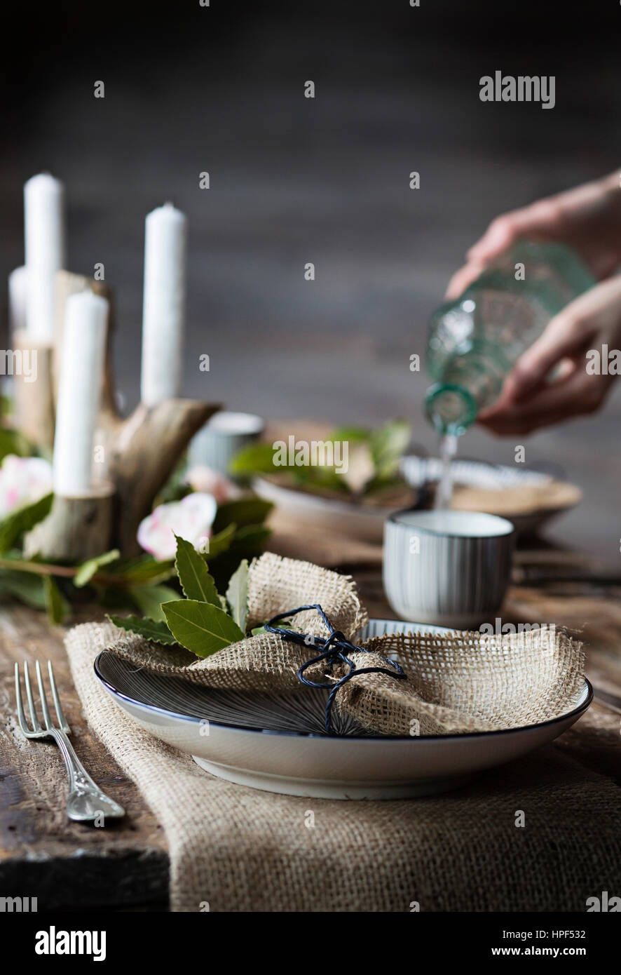 Table setting. Hands of woman pouring water on the background Stock ...