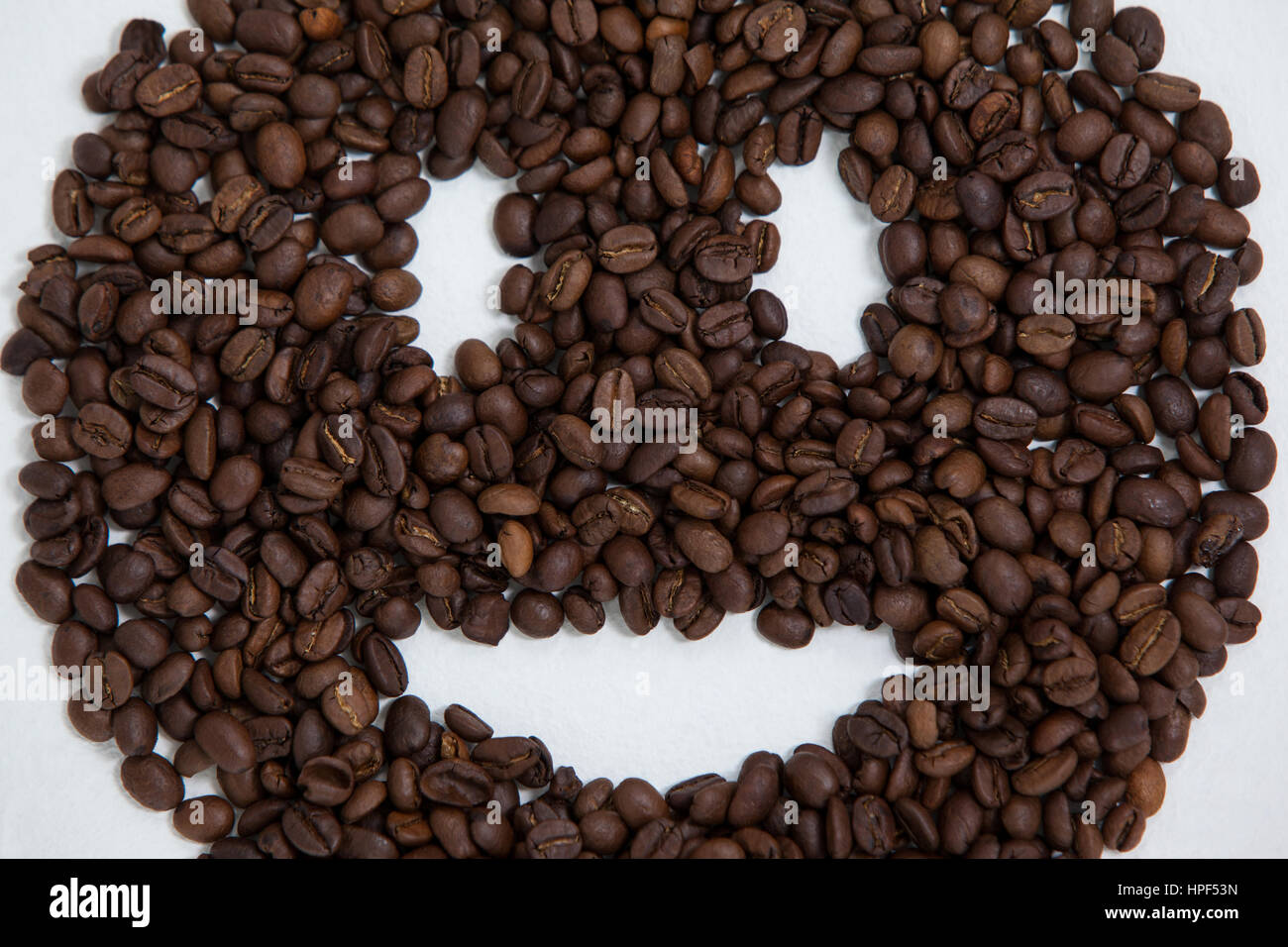 Coffee beans forming smiley face on white background Stock Photo - Alamy