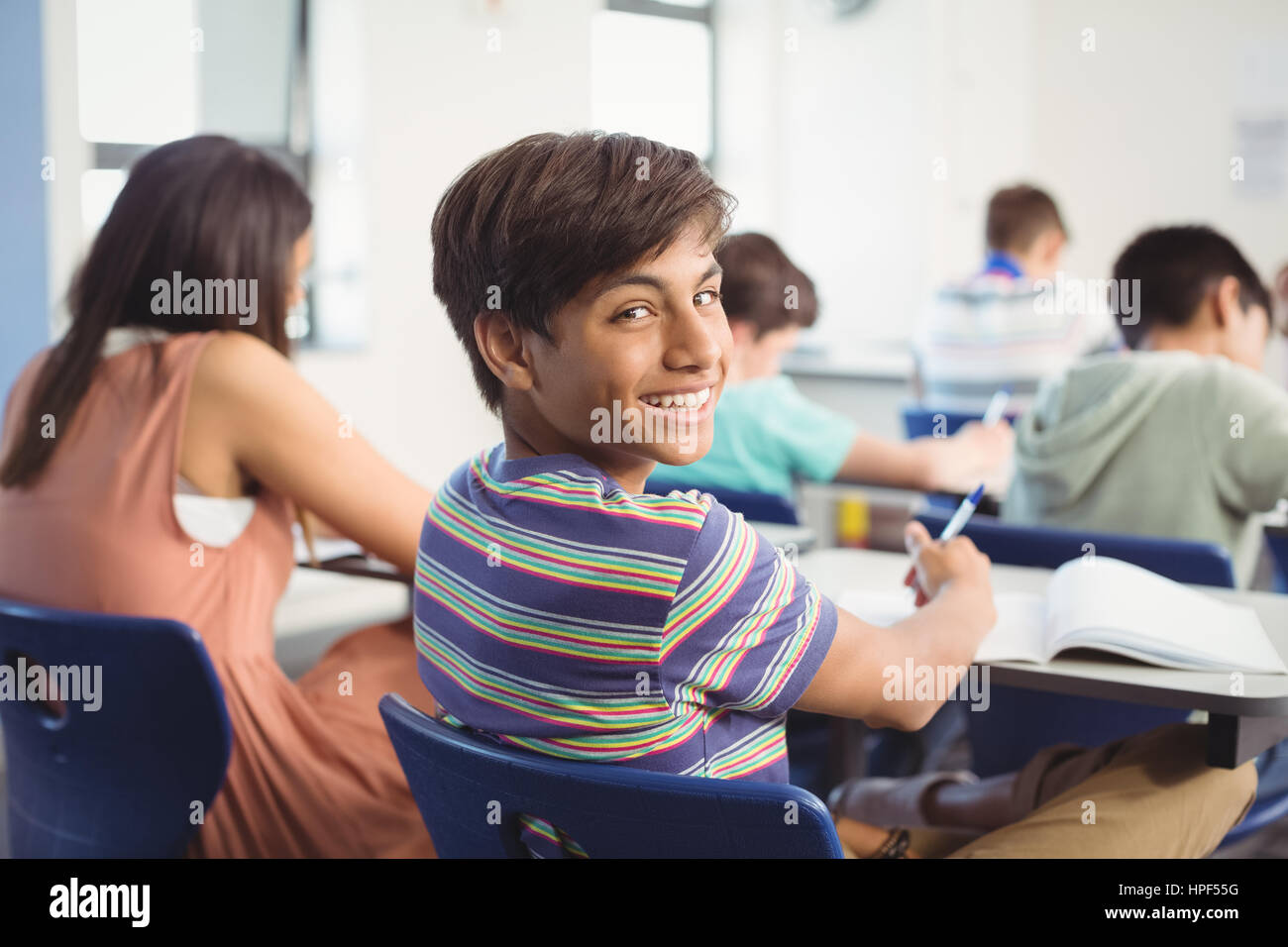 School kids doing homework in classroom at school Stock Photo - Alamy