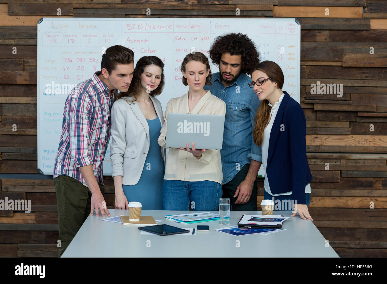 Business team discussing over laptop in meeting at office Stock Photo ...