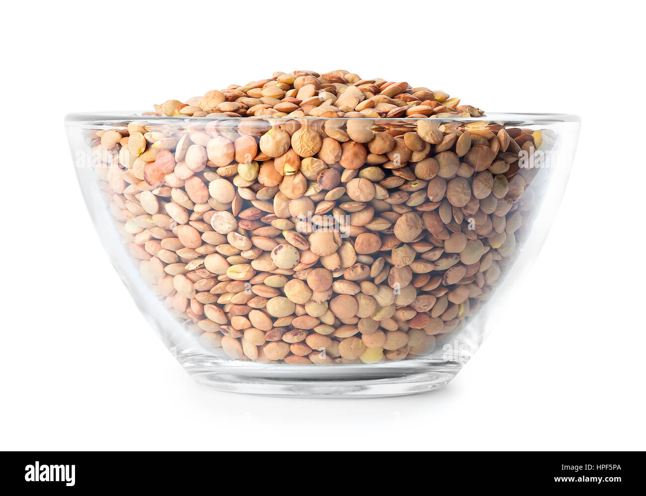 dry lentils in glass bowl isolated on white background. Uncooked grains ...