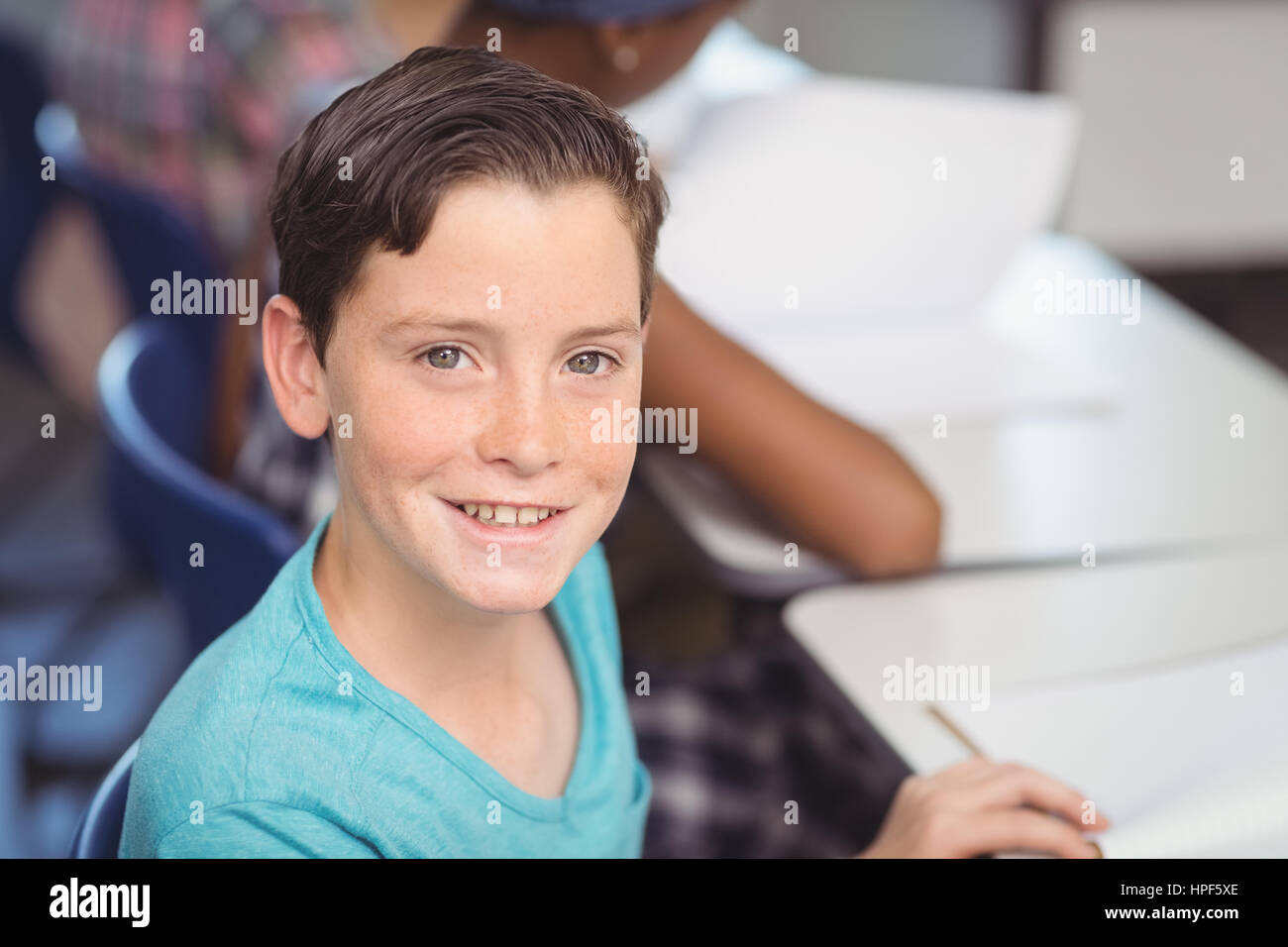 Portrait of smiling schoolboy in school Stock Photo - Alamy