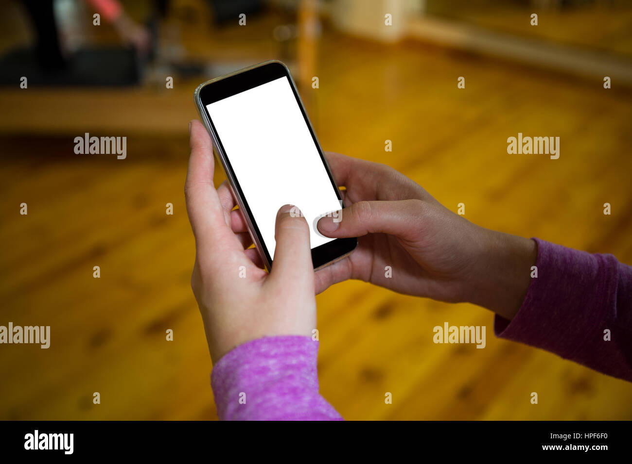 Hand on a woman using mobile phone in gym Stock Photo - Alamy