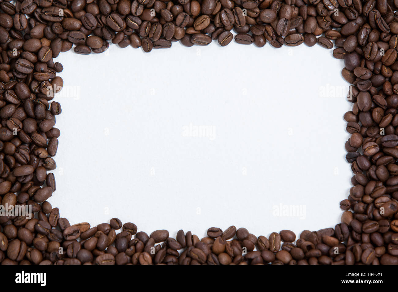 Coffee beans forming rectangle on white background Stock Photo - Alamy