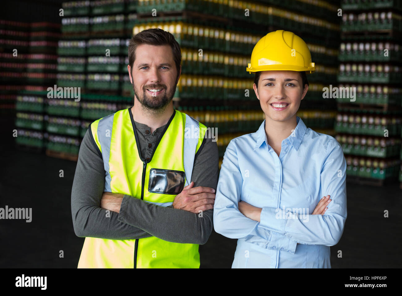 Portrait of factory workers standing with arms crossed in factory Stock ...
