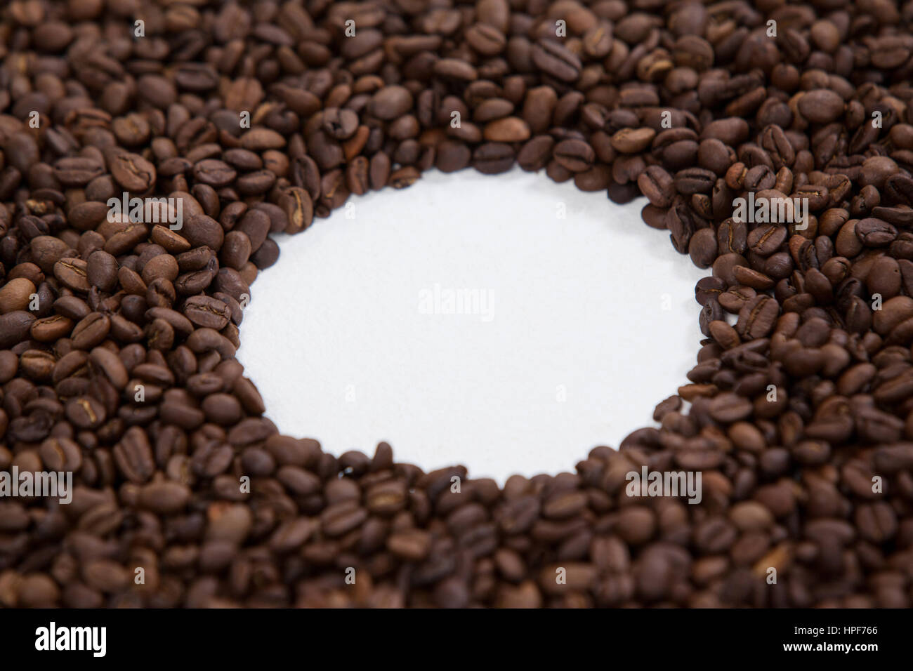 Coffee beans forming circle shape on white background Stock Photo - Alamy