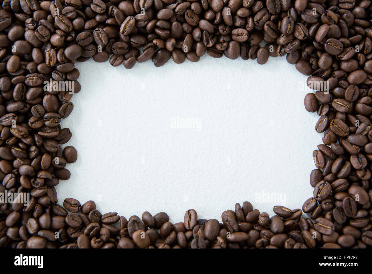 Frame made from roasted coffee beans on white background Stock Photo ...