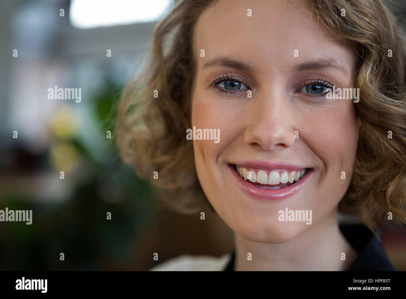 Portrait of female graphic designer smiling in creative office Stock ...