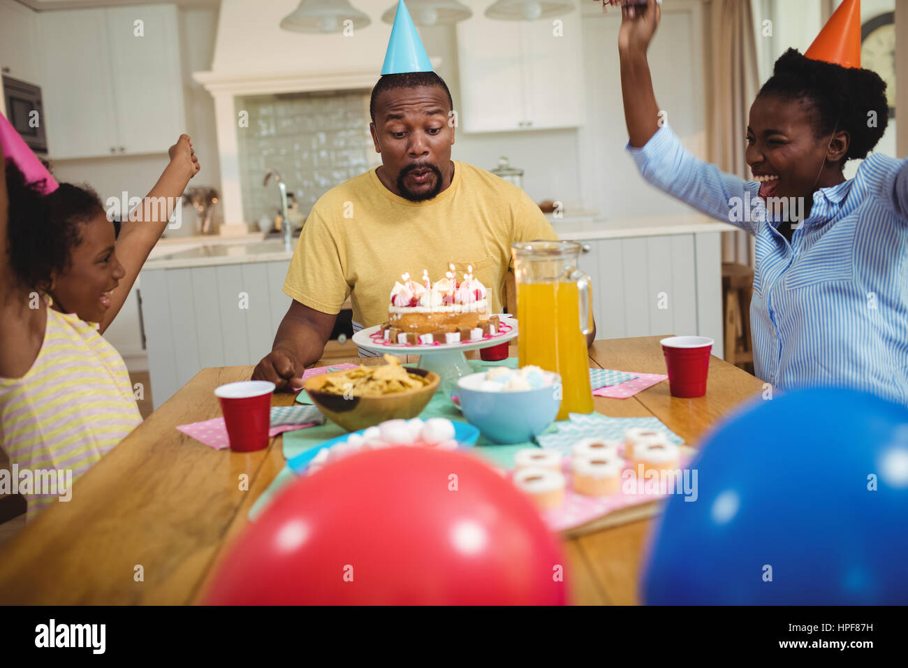 Family celebrating a birthday at home Stock Photo - Alamy