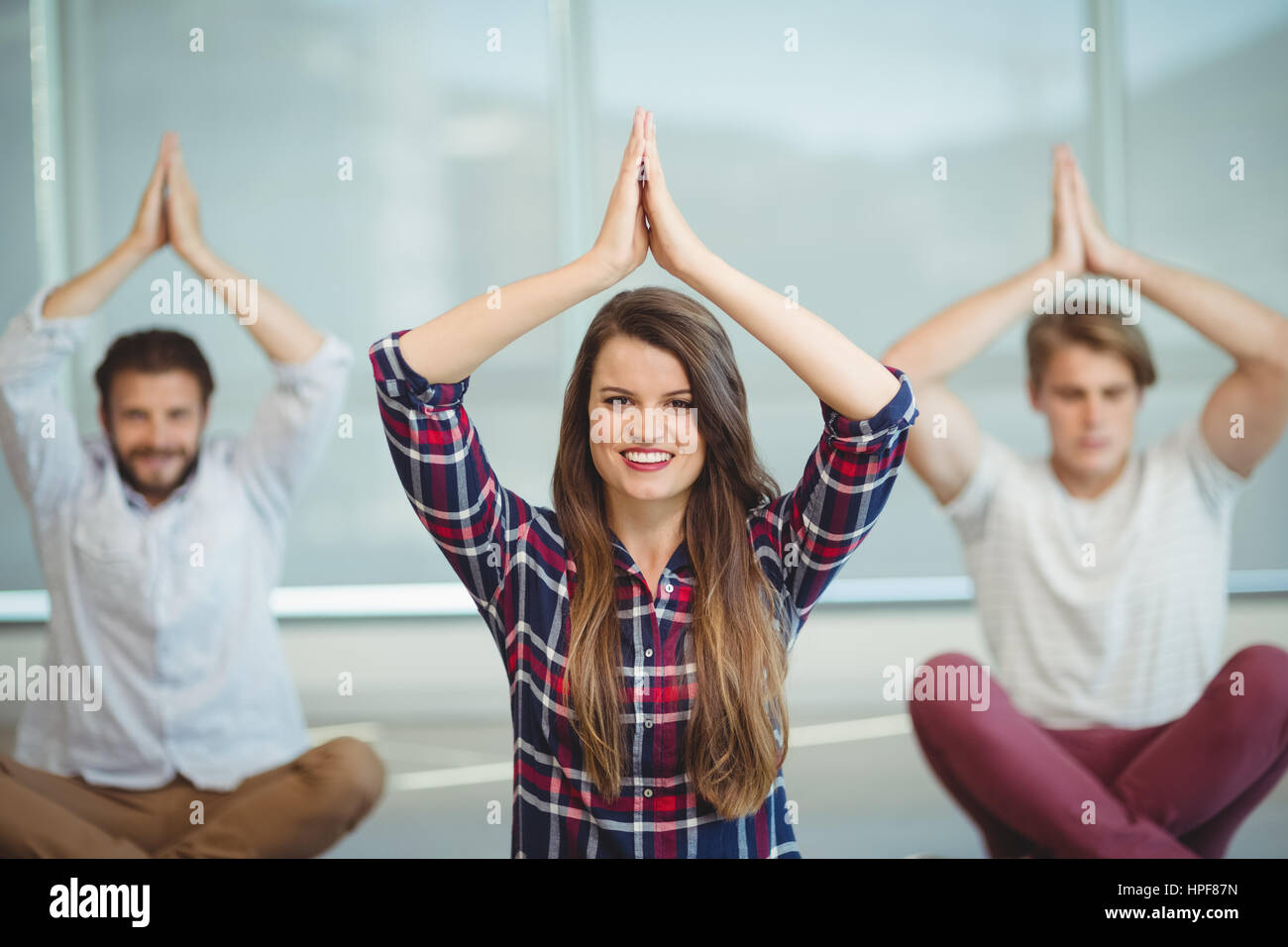 Business executives practicing yoga in office Stock Photo - Alamy
