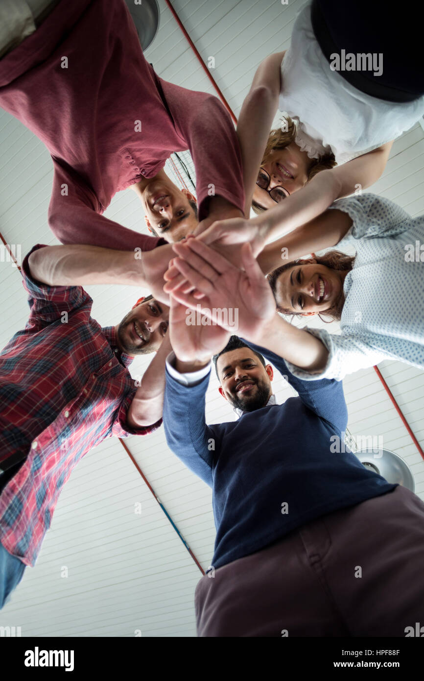 Team of businesspeople forming hand stack in office Stock Photo - Alamy