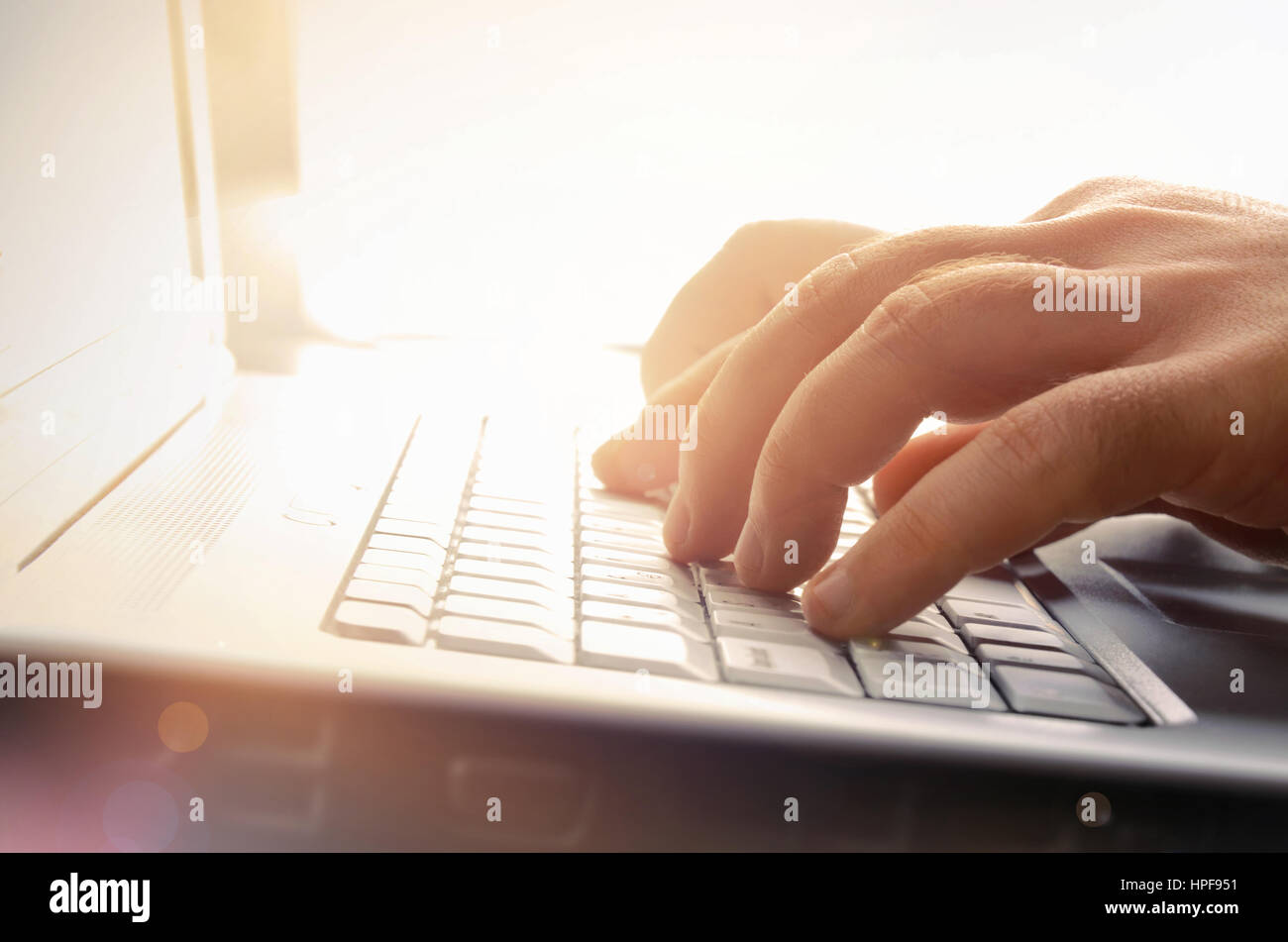 Man's hands typing on laptop keyboard. Image can be used for background ...