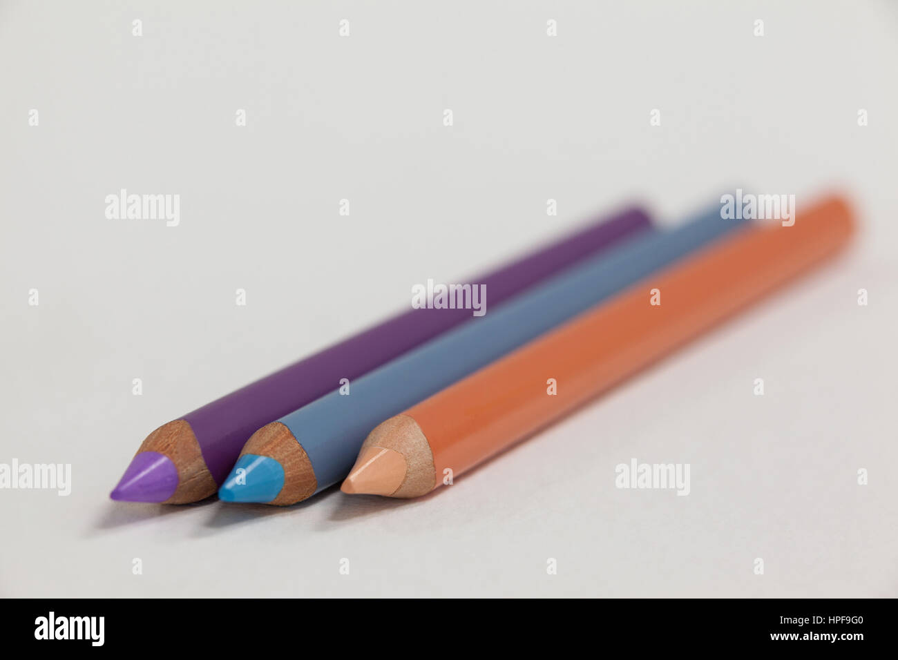Close-up of three colored pencils on white background Stock Photo - Alamy
