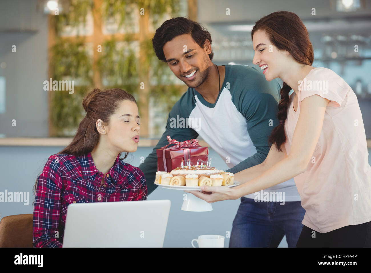 Business executives celebrating their colleagues birthday in office ...