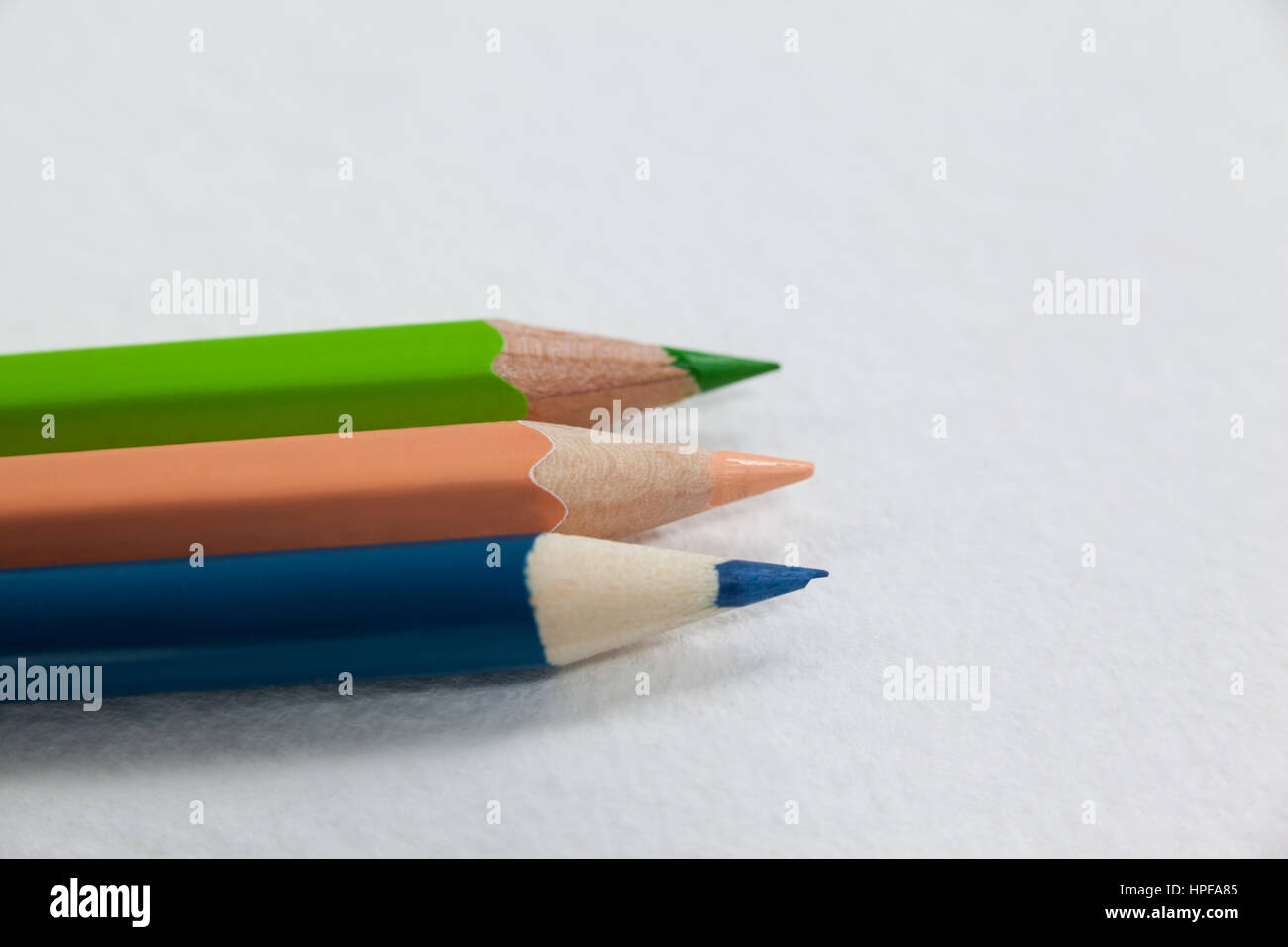 Close-up of three colored pencils on white background Stock Photo - Alamy