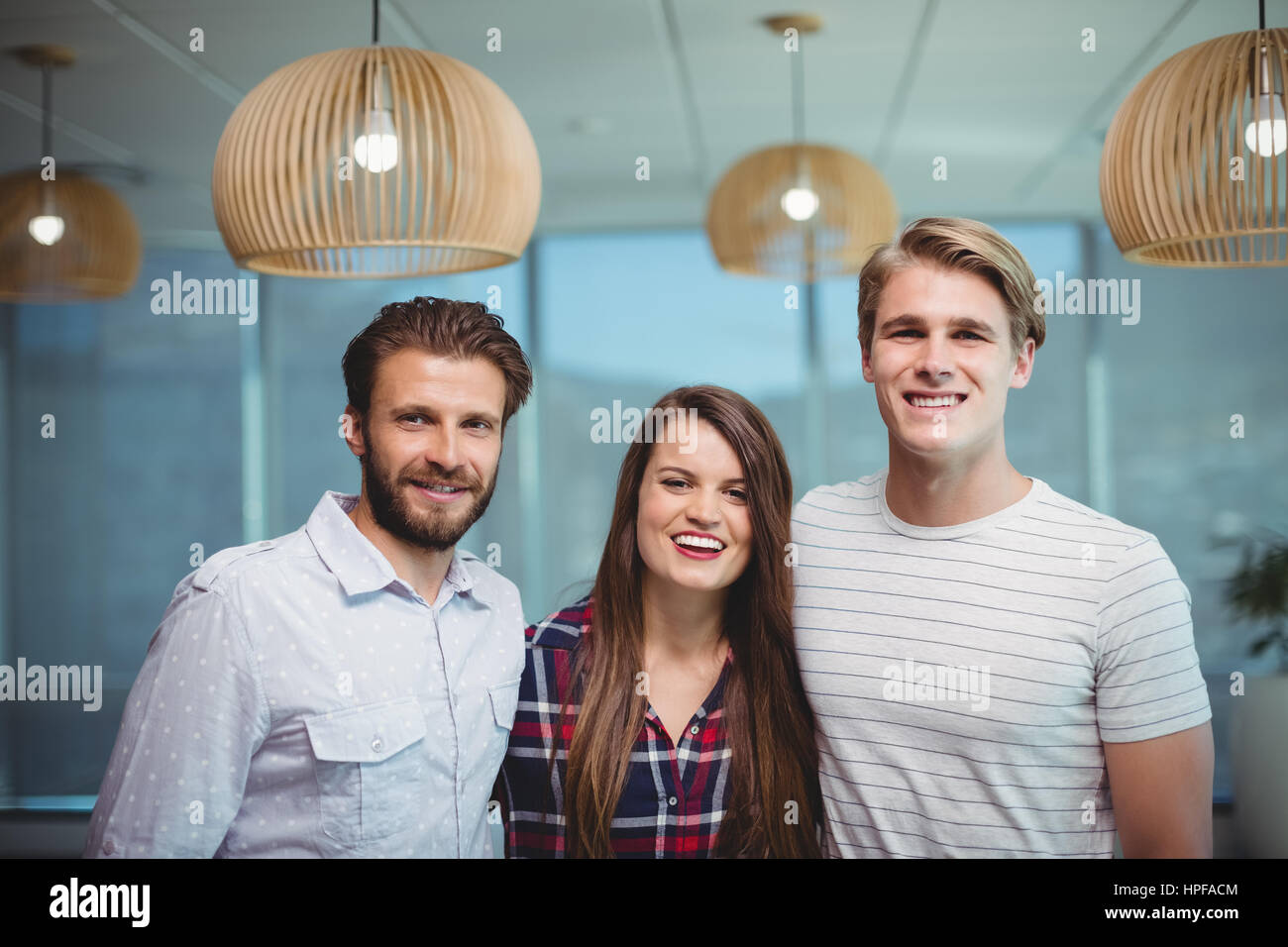 Portrait happy business executives standing together in office Stock ...