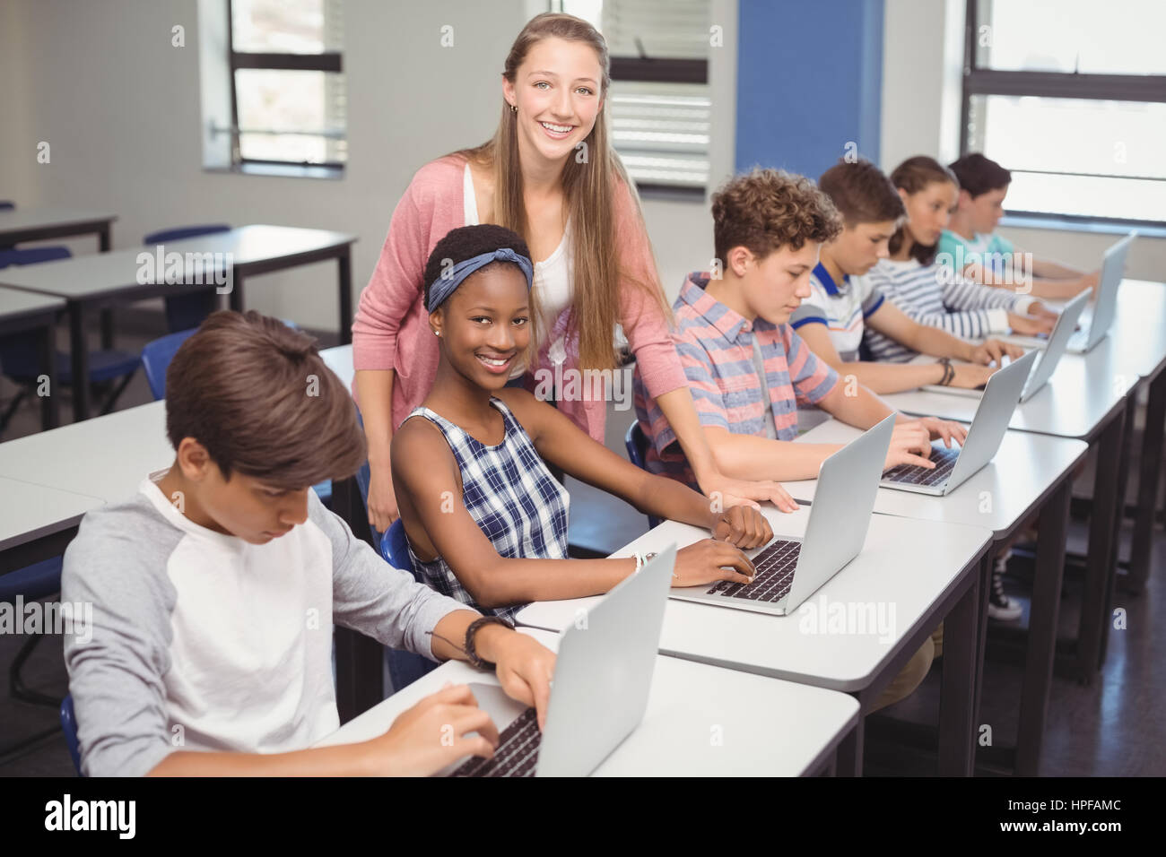 Students using laptop in classroom at school Stock Photo - Alamy