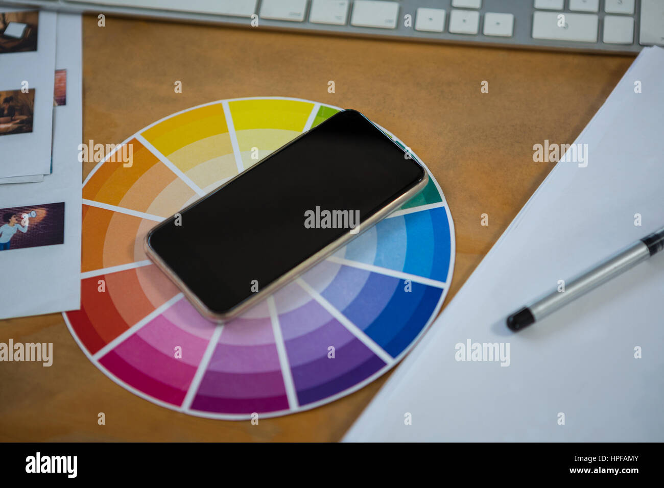 Close-up of mobile phone with color swatch on office desk Stock Photo ...
