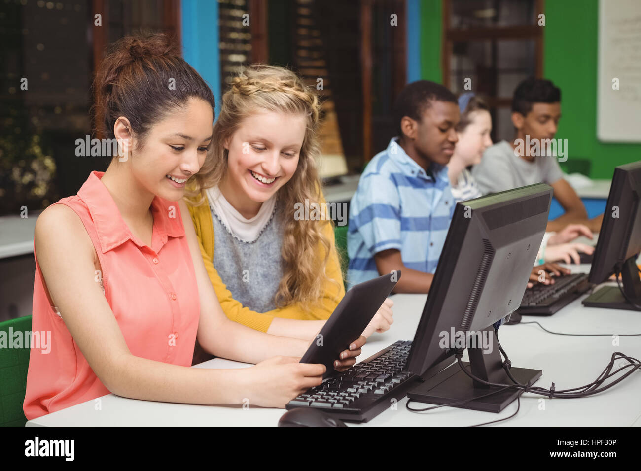Smiling students studying in computer classroom at school Stock Photo ...