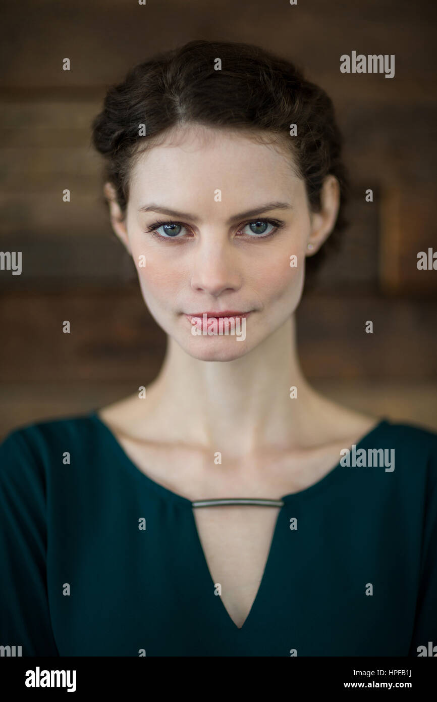 Portrait of confident female business executive standing in office ...