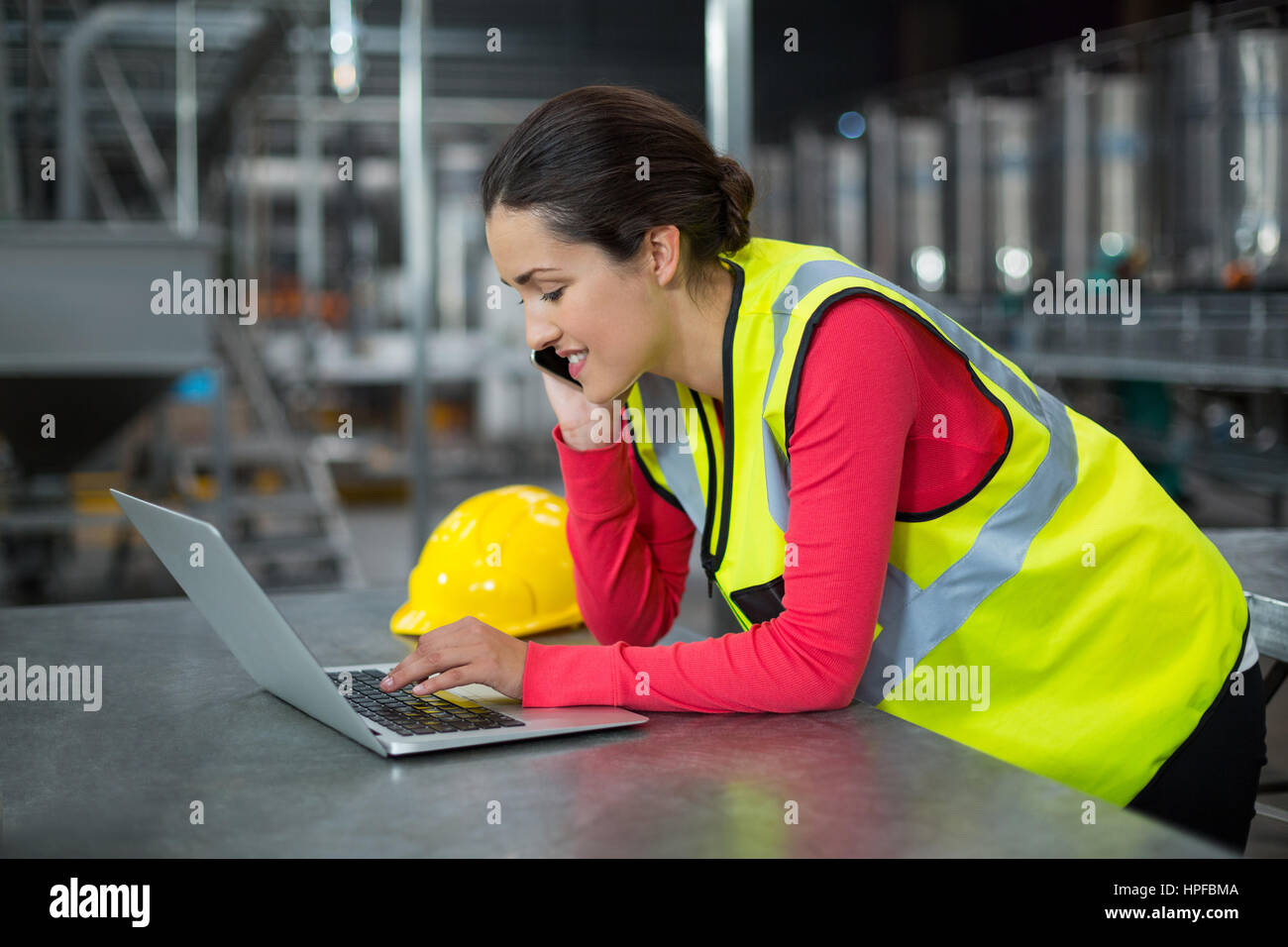 Female production worker smartphone hi-res stock photography and images ...