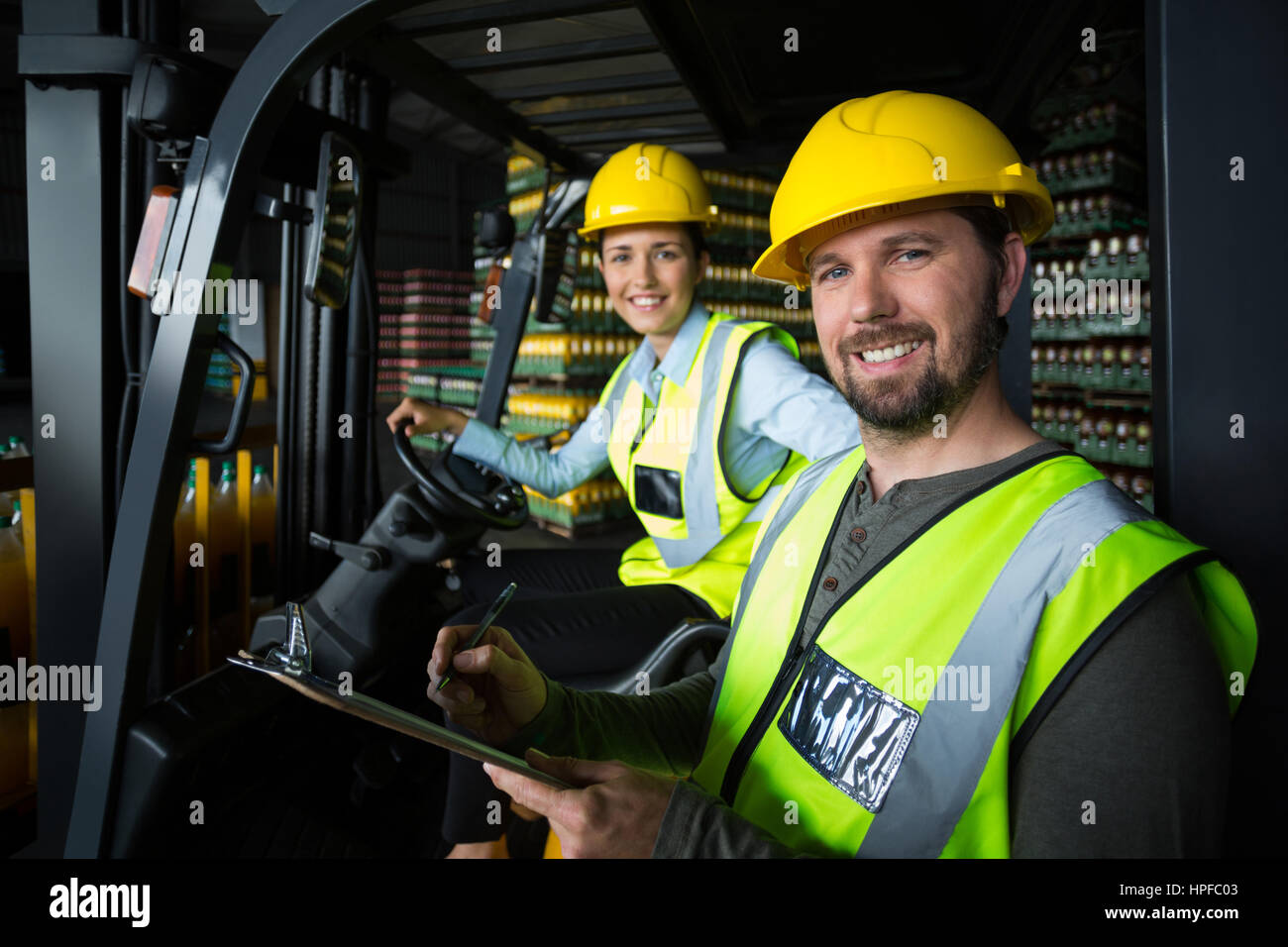 Portrait of smiling factory workers in factory Stock Photo - Alamy