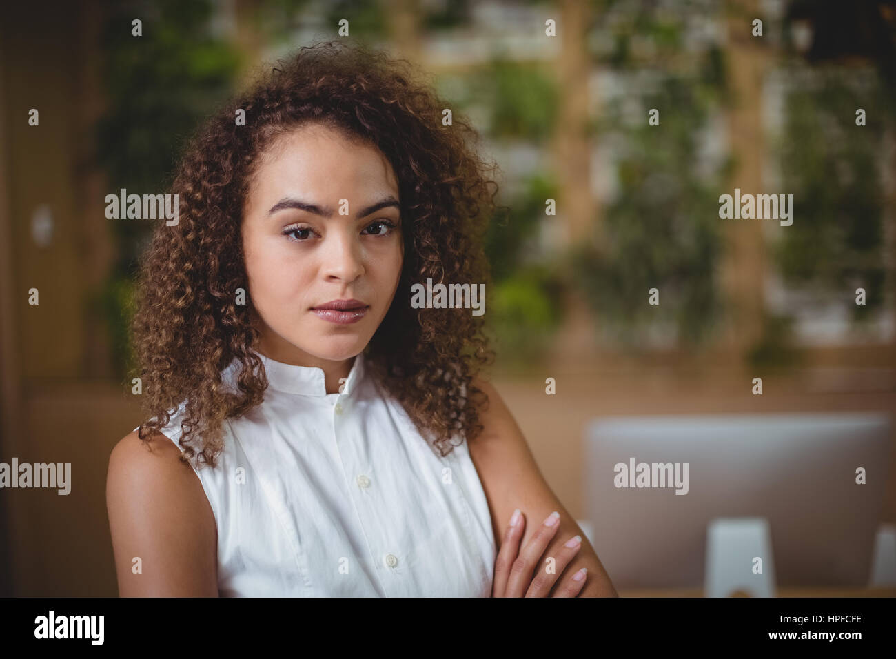 Beautiful female executive standing in office Stock Photo - Alamy