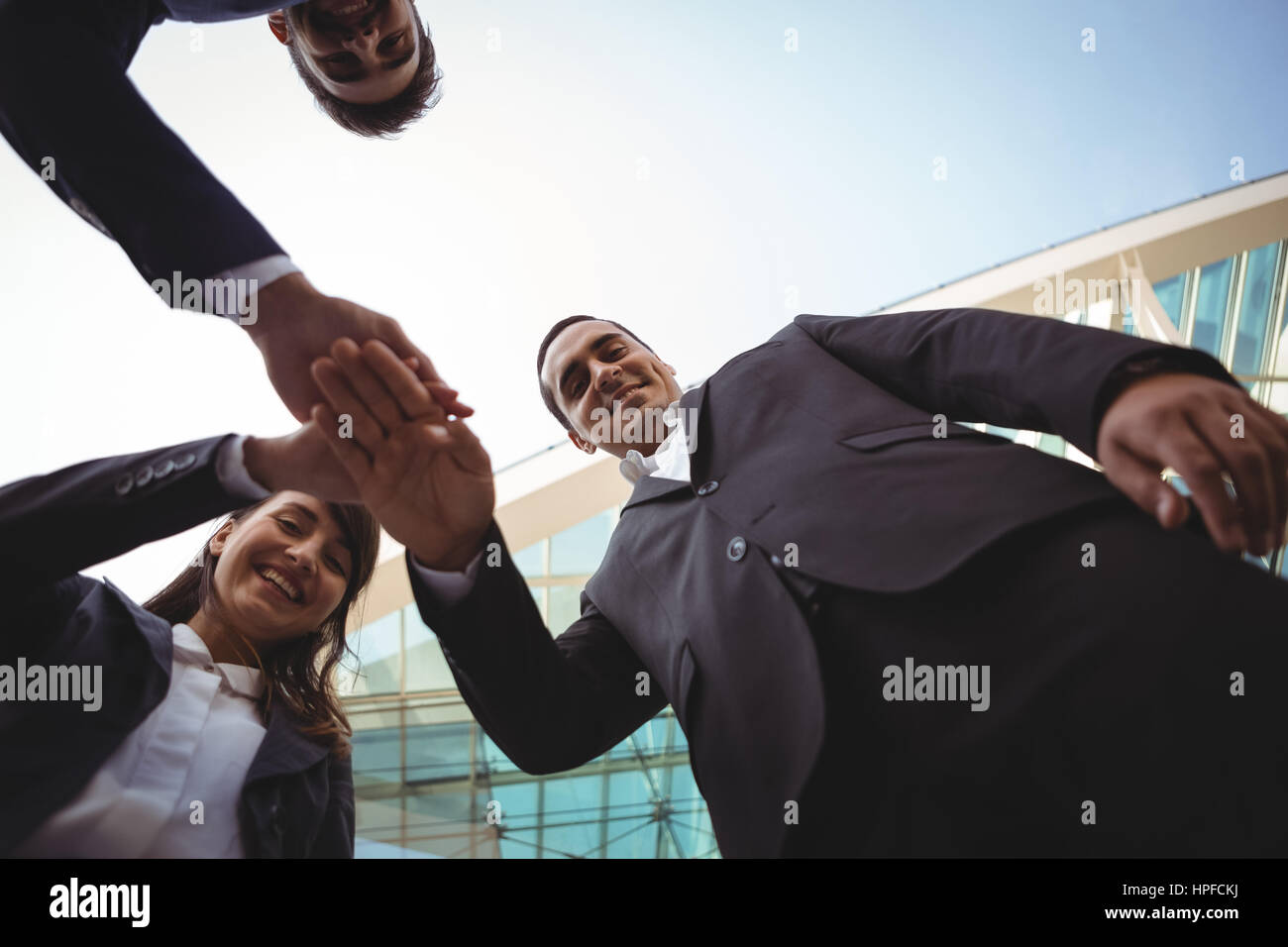 Executives forming hand stack hi-res stock photography and images - Alamy