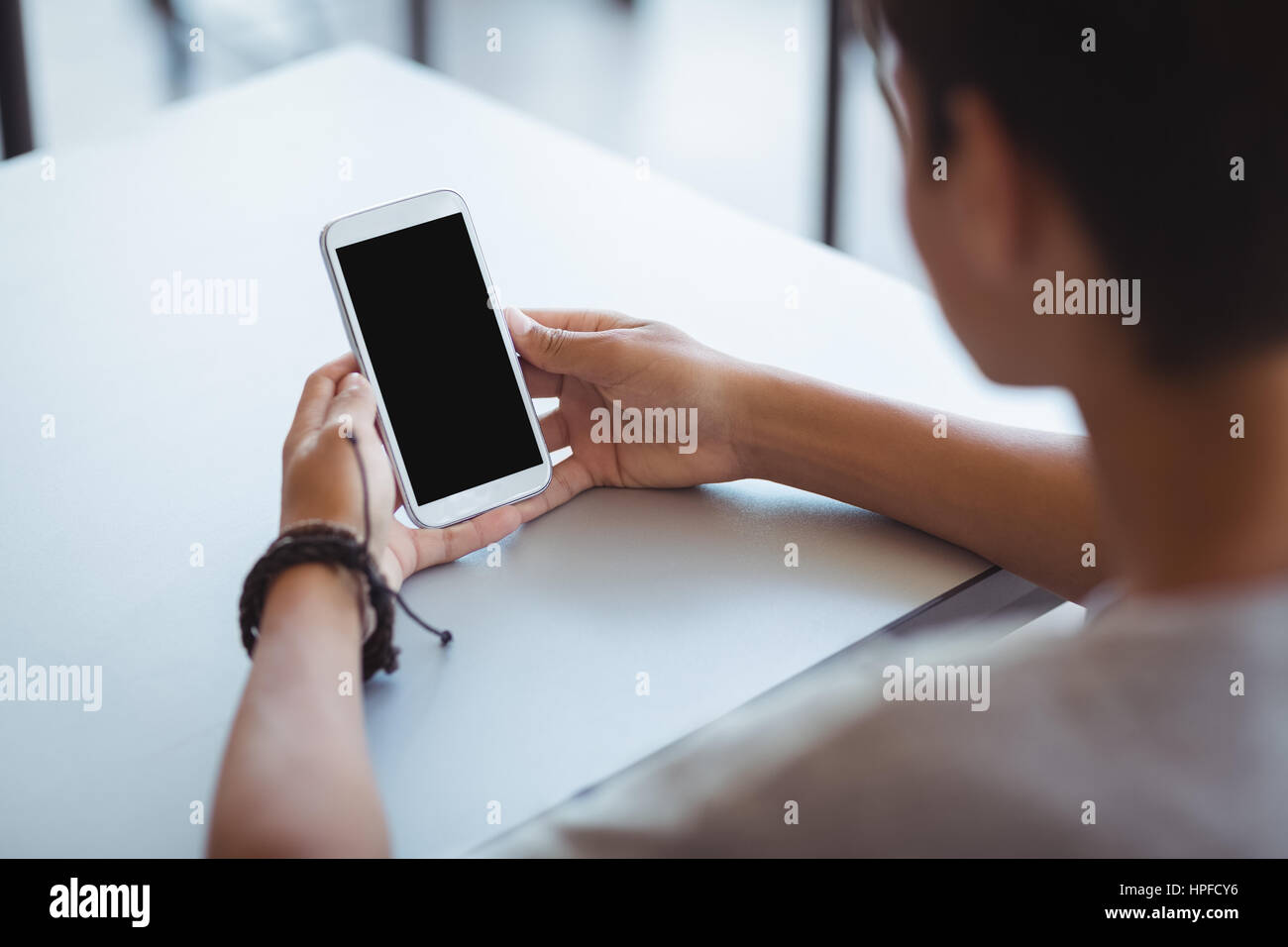 Schoolboy using mobile phone in classroom at school Stock Photo - Alamy