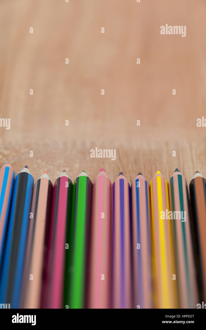 Close-up of colored pencils arranged in a row on white background Stock ...