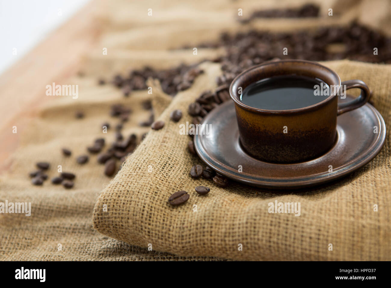 Black coffee served on sack with coffee beans on sack textile Stock ...