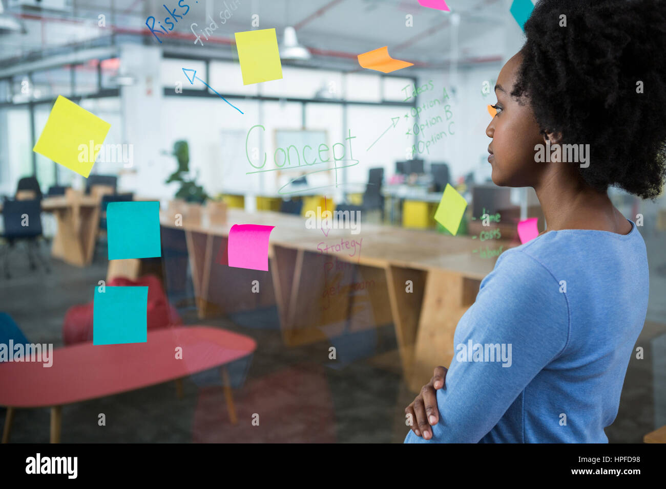 Beautiful female graphic designer looking at the glass Stock Photo - Alamy
