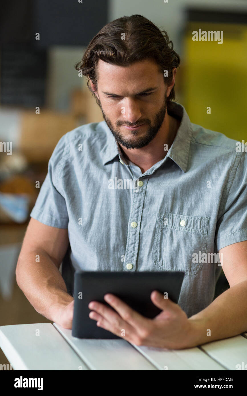 Male staff using digital tablet at counter in grocery shop Stock Photo ...