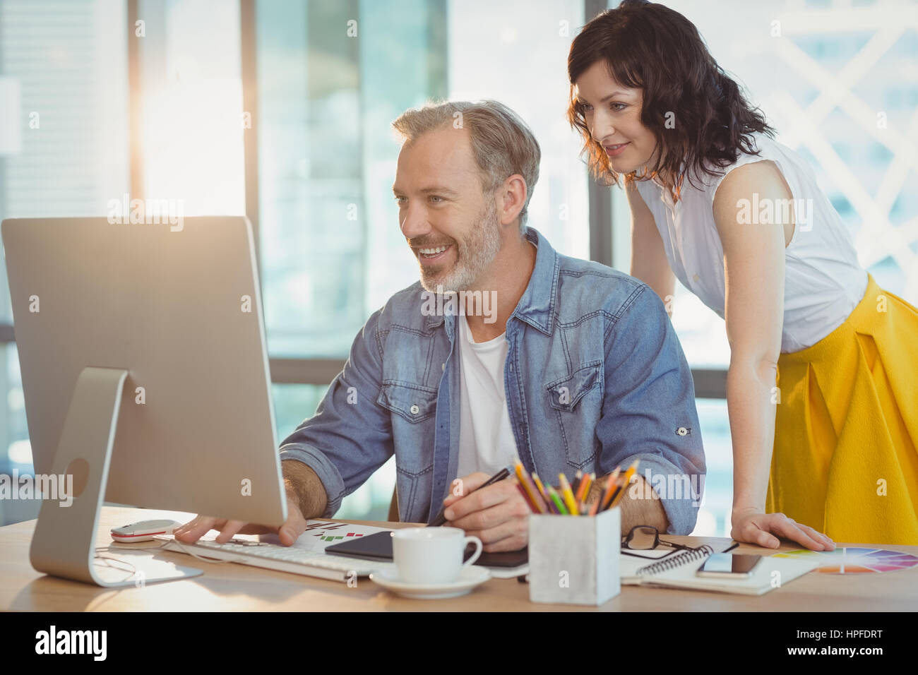 Male graphic designers using graphics tablet in office Stock Photo - Alamy