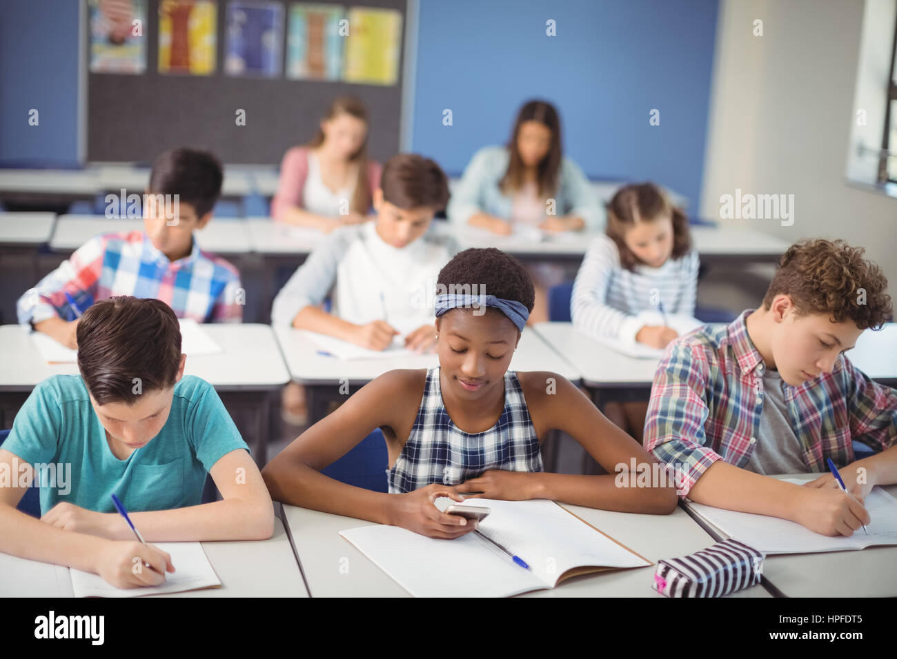 Students studying in classroom at school Stock Photo - Alamy