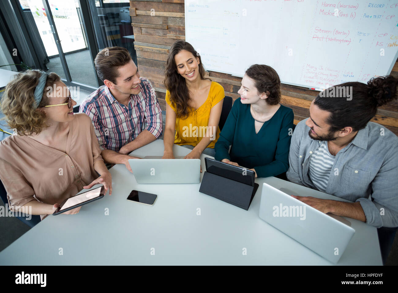 Business executives discussing with each other in meeting at office ...