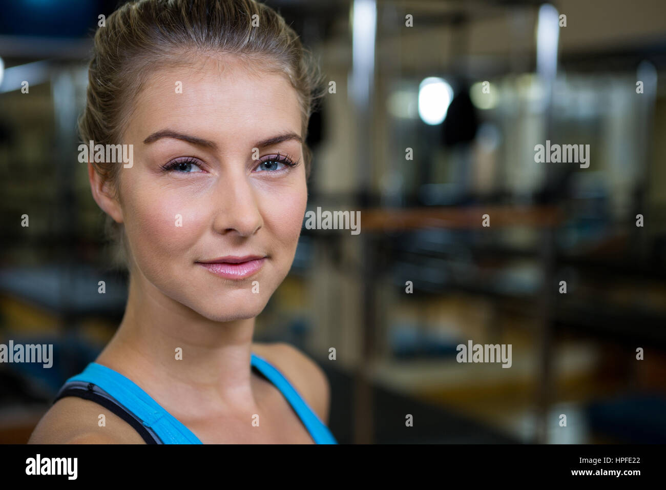 Portrait of smiling fit woman in fitness studio Stock Photo - Alamy