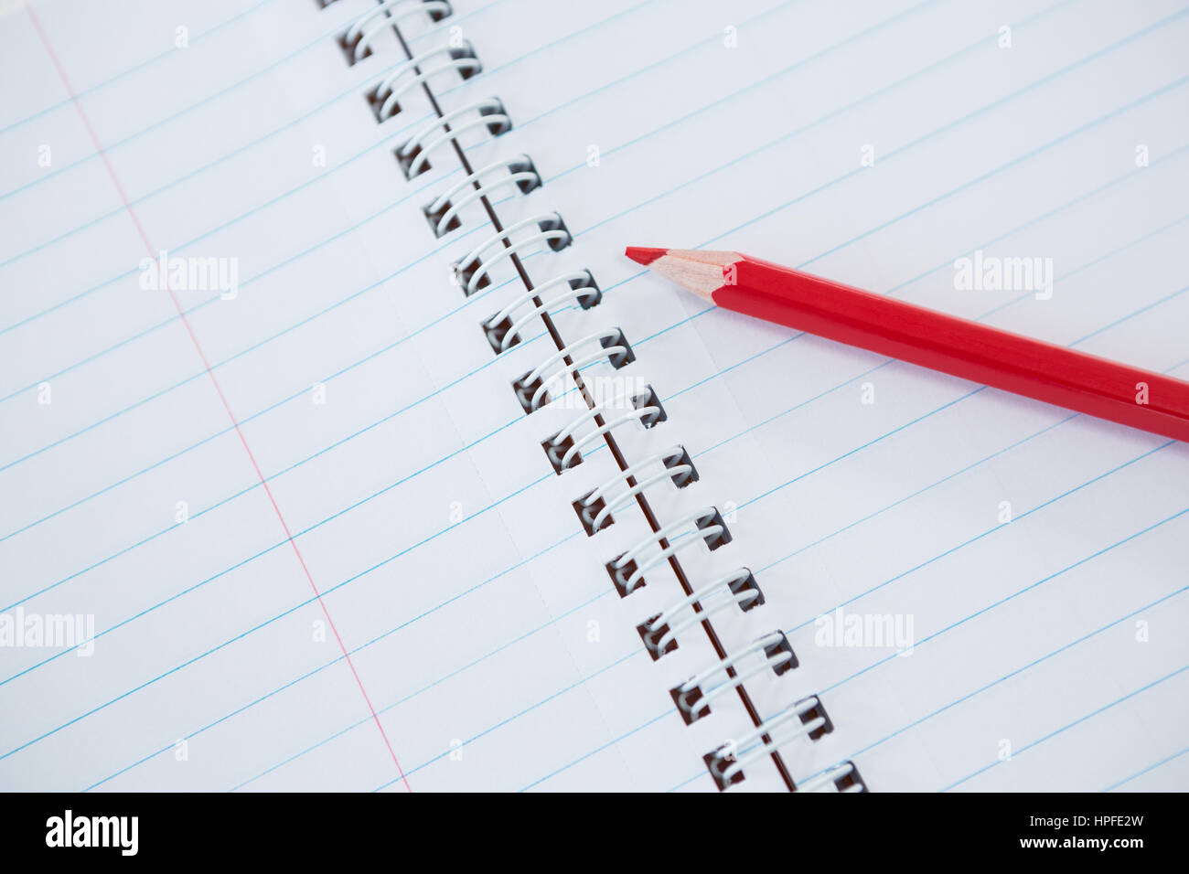 Close-up of red color pencil kept on the book Stock Photo - Alamy