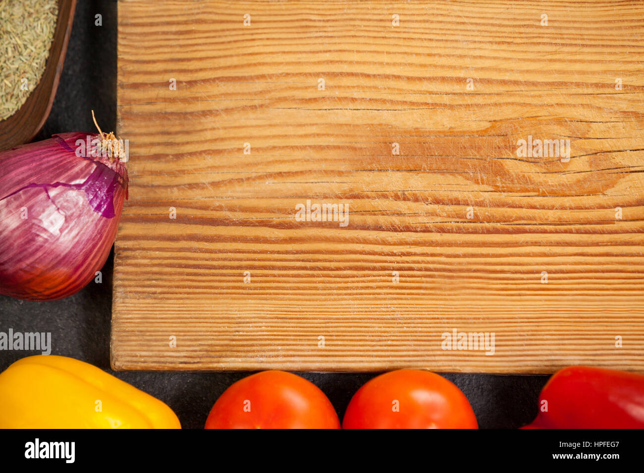 Wooden tray with ingredients against black background Stock Photo - Alamy