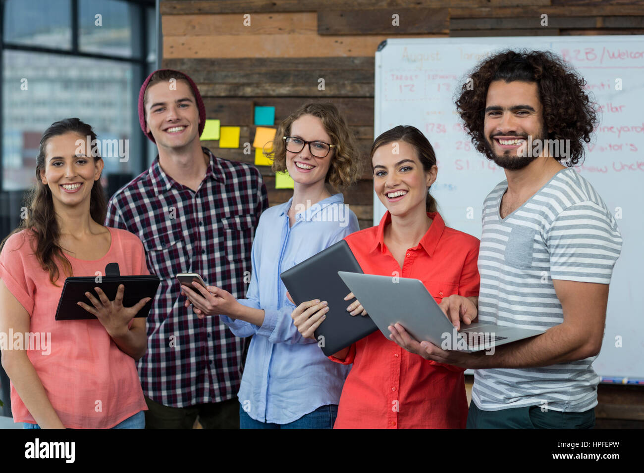 Portrait of business executives working in office Stock Photo - Alamy