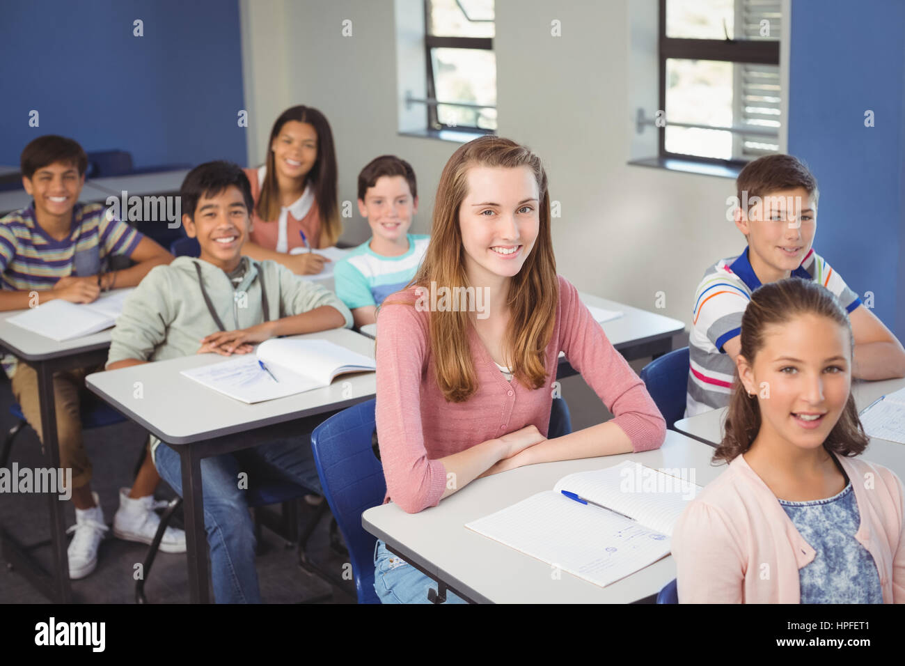 Portrait of smiling school kids sitting in classroom at school Stock ...