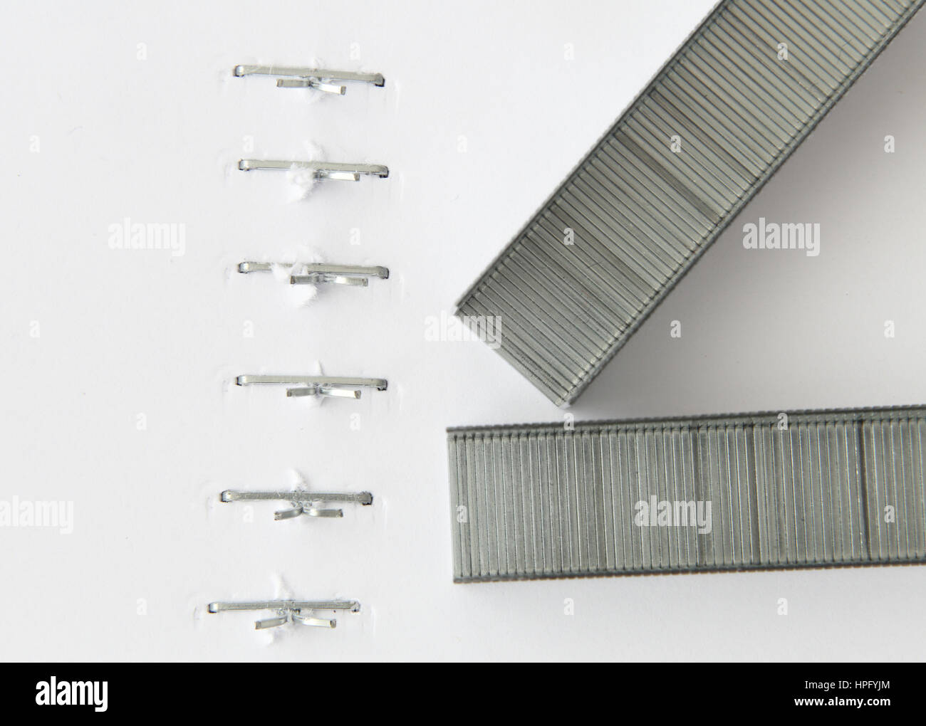 Staples in a stapled papers close up view Stock Photo - Alamy
