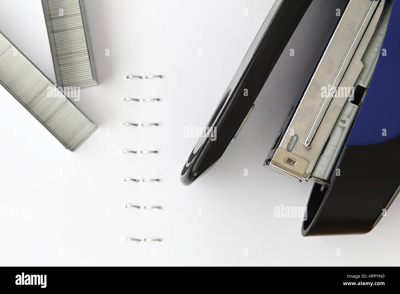 Blue stapler stapling papers closeup view isolated on white Stock Photo ...