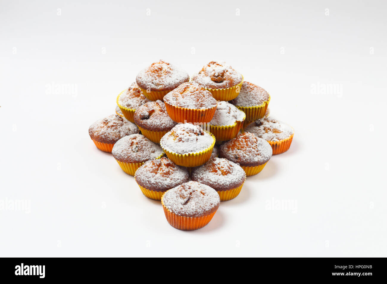 Stack of tasty isolated muffins on white background Stock Photo - Alamy