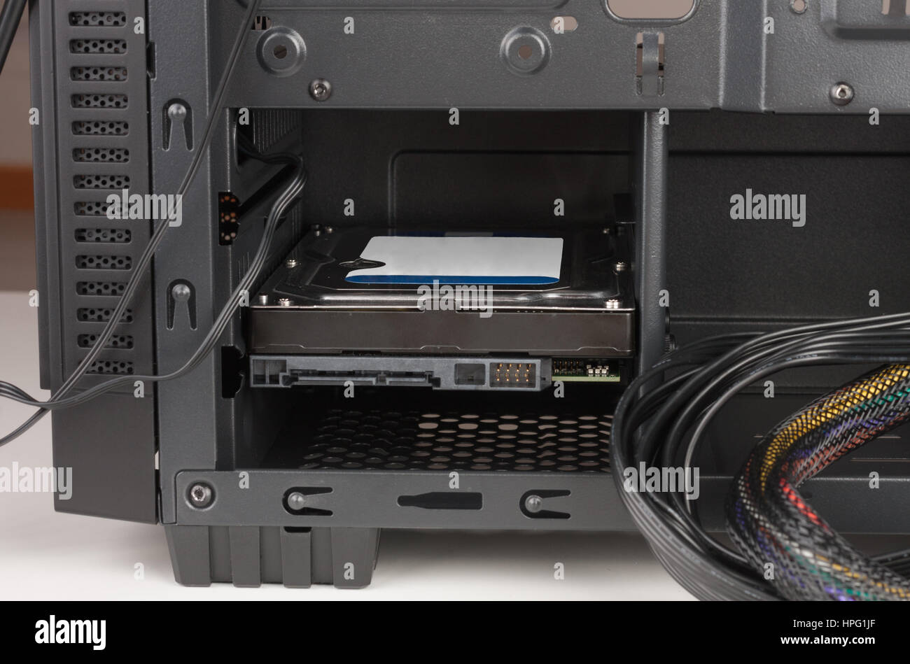 Internal hard drive inserted in computer case Stock Photo - Alamy